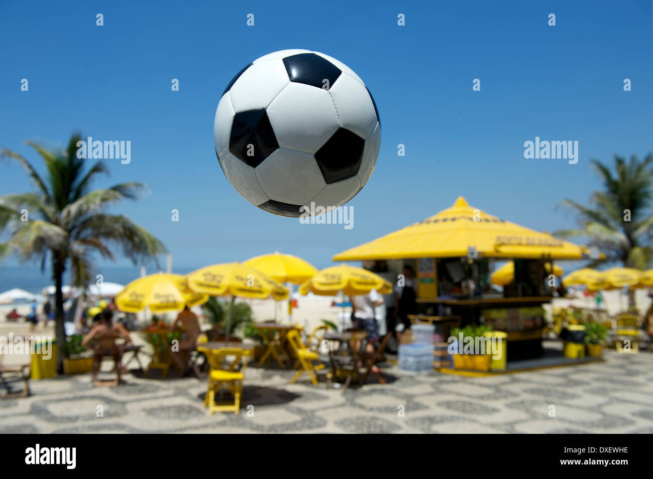 Football soccer ball flying in front of boardwalk kiosk in Ipanema ...