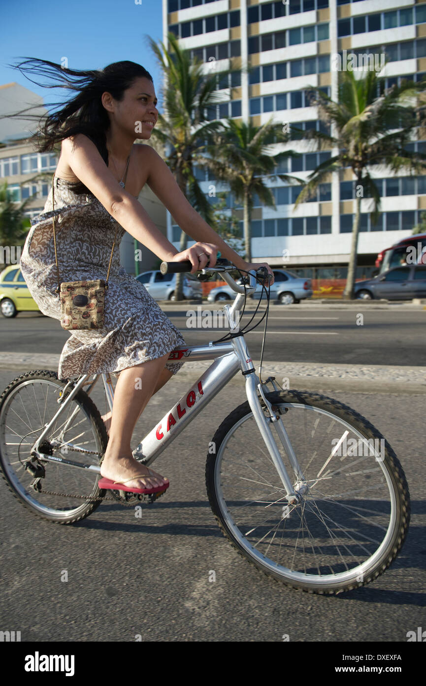 RIO DE JANEIRO, BRAZIL - JANUARY 31, 2014: A Brazilian woman rides a ...