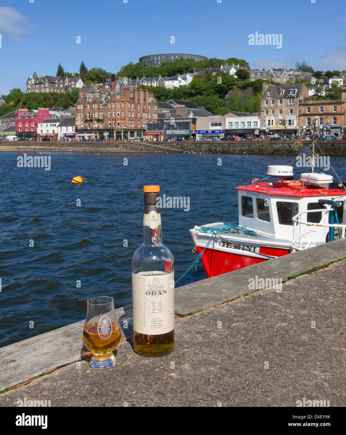 Oban Whisky Glass & Bottle with Oban in the background, Argyll Stock ...