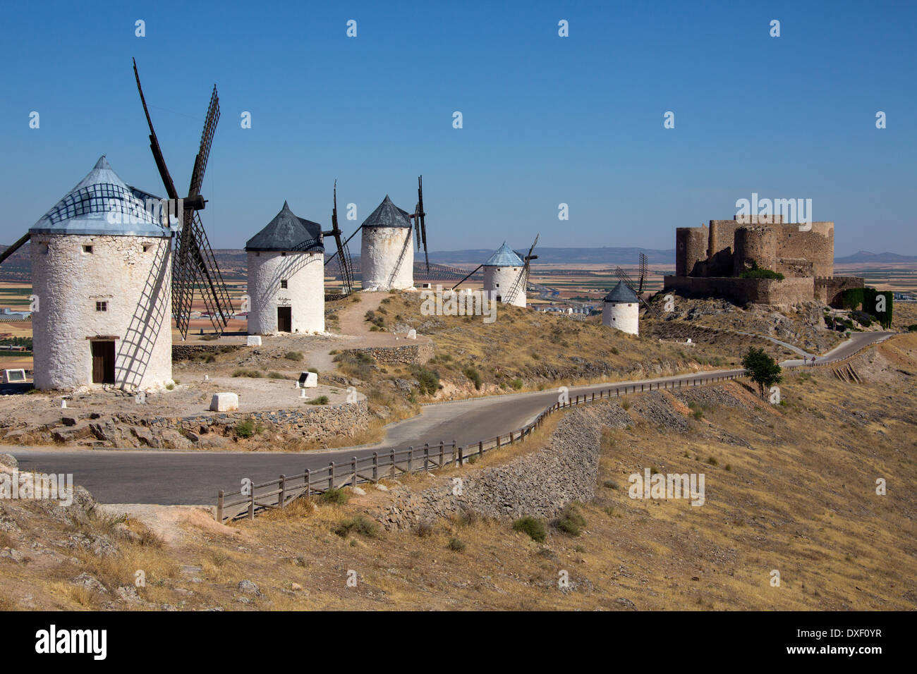 The windmills and castle of Consuegra in the La Mancha region of ...