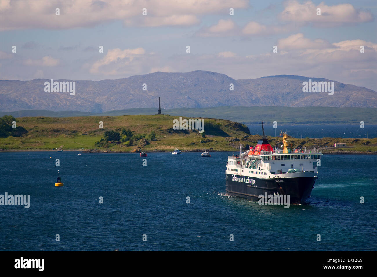 The isle of Mull ferry arrives in Oban bay with the islands of kerrera ...