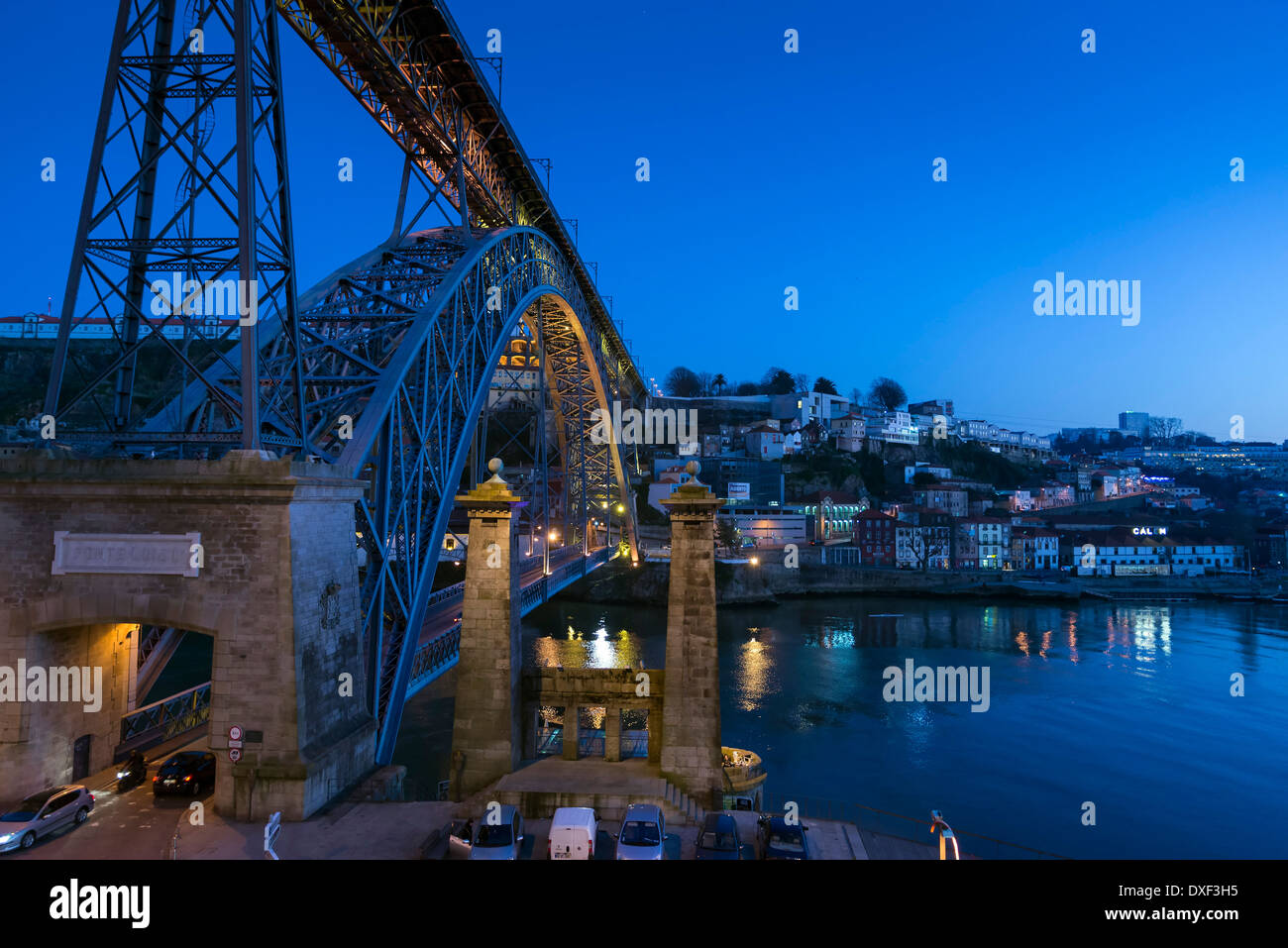 Colorful view of sunset along the riverfront with lights reflecting in ...