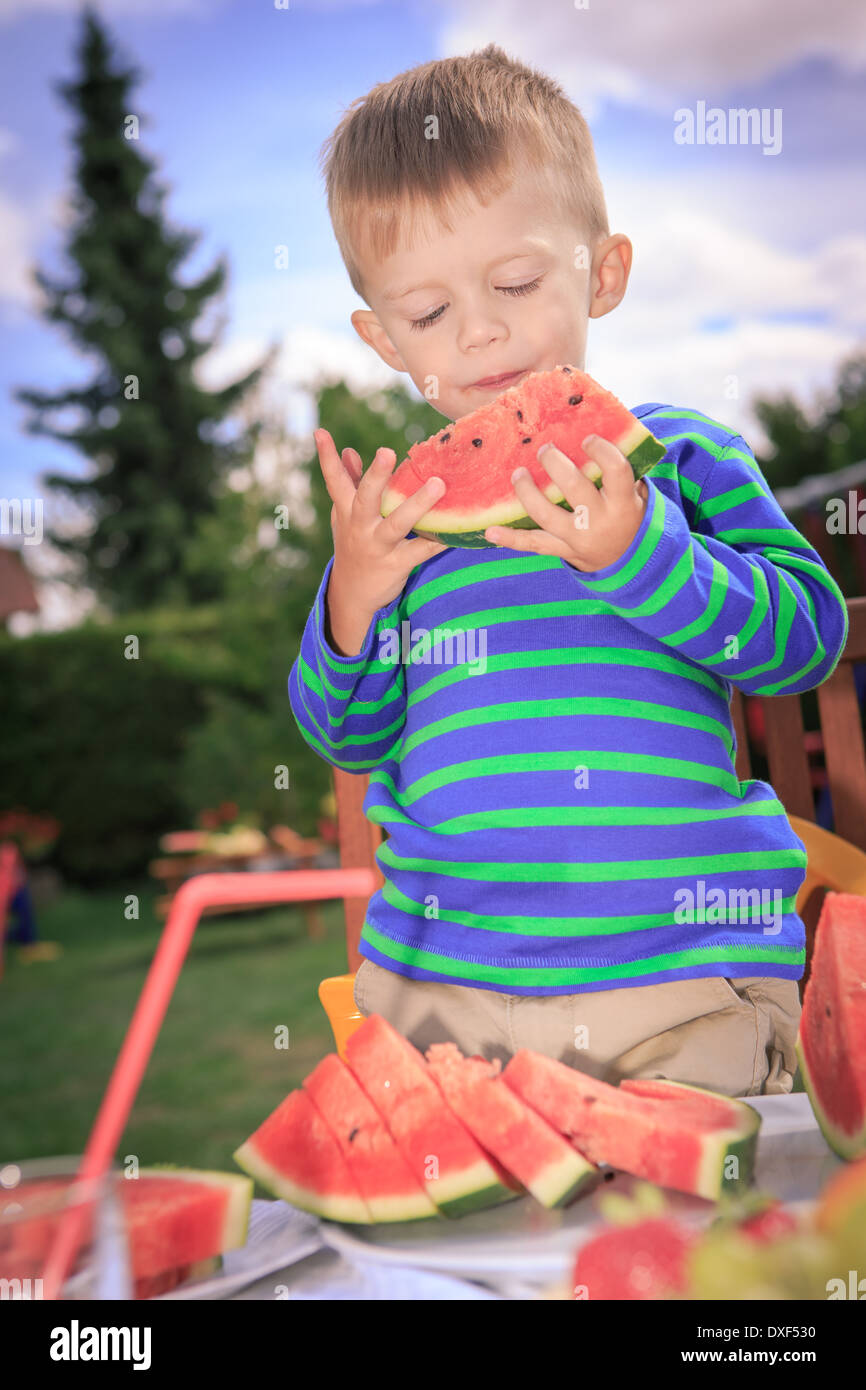 little boy eating a watermelon in the garden Stock Photo - Alamy