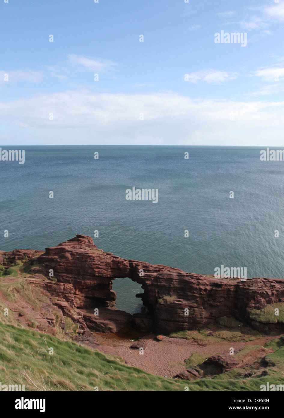 Elevated view of Needle E'e rock arch in red sandstone Seaton Cliffs ...