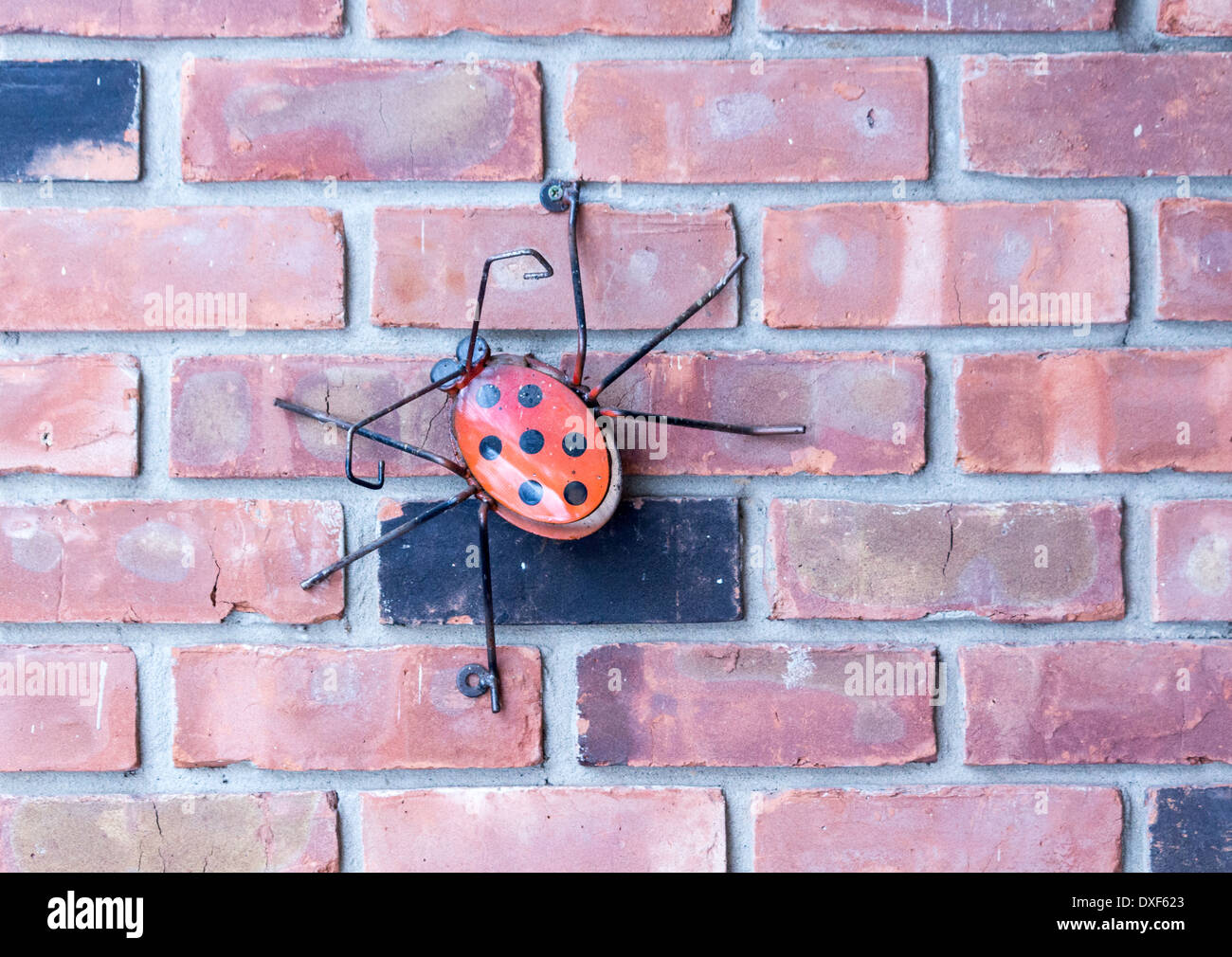 Steel ladybug decoration mounted into the brick on the side of a house ...