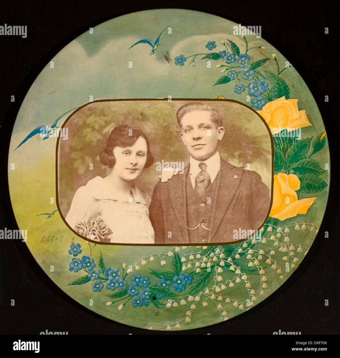 This historical photograph shows a bride and groom, captured in a ...