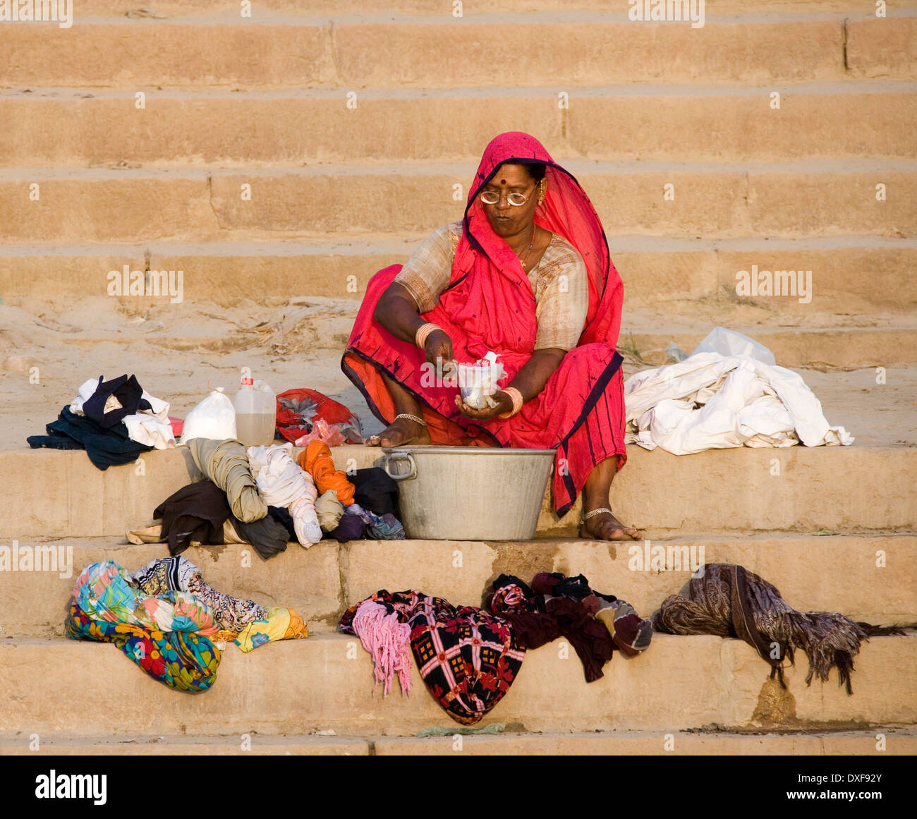 Indian Woman Washing Clothes On The Hindu Ghats By The River Ganges In