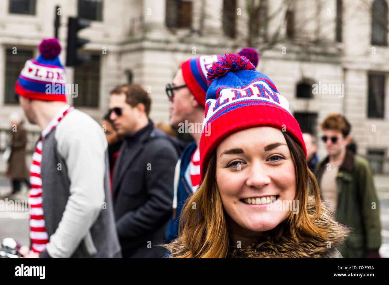 A happy smiling tourist wearing a colourful I Love London hat Stock ...