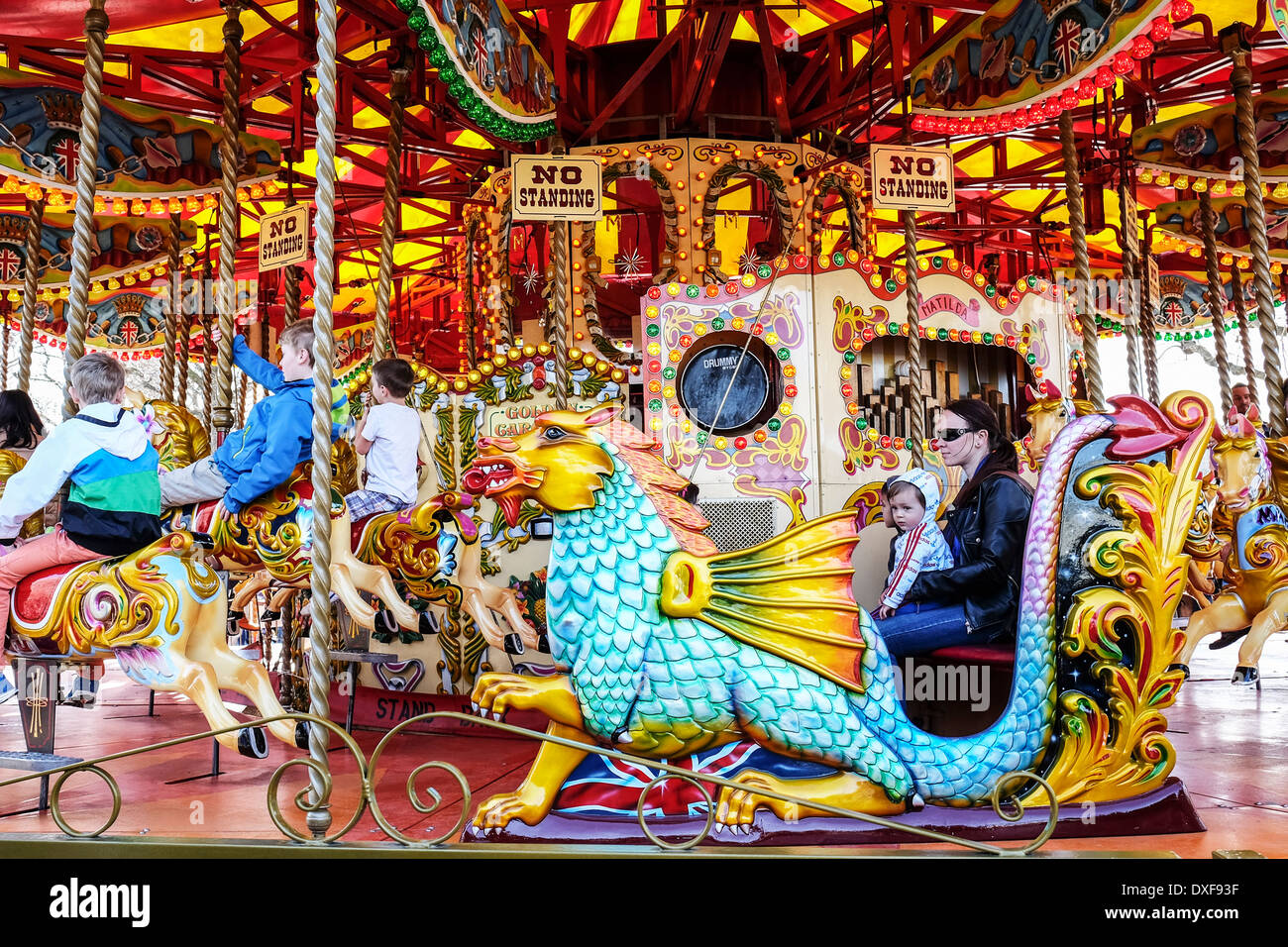People riding on a traditional fairground carousel Stock Photo - Alamy