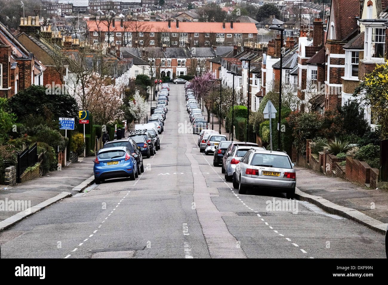 A street with cars parked on both sides Stock Photo - Alamy