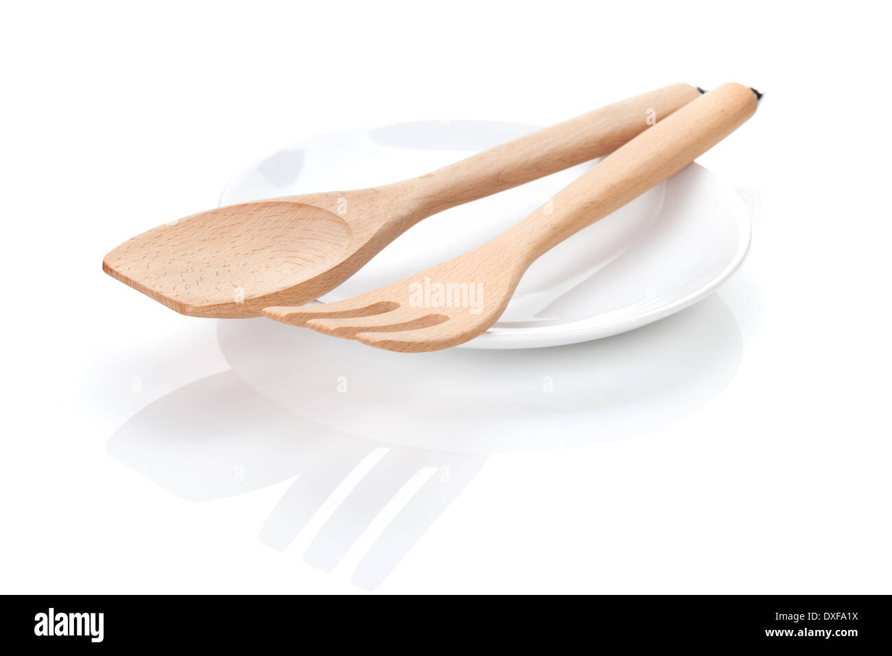 Kitchen utensils over plate. Isolated on white background Stock Photo ...