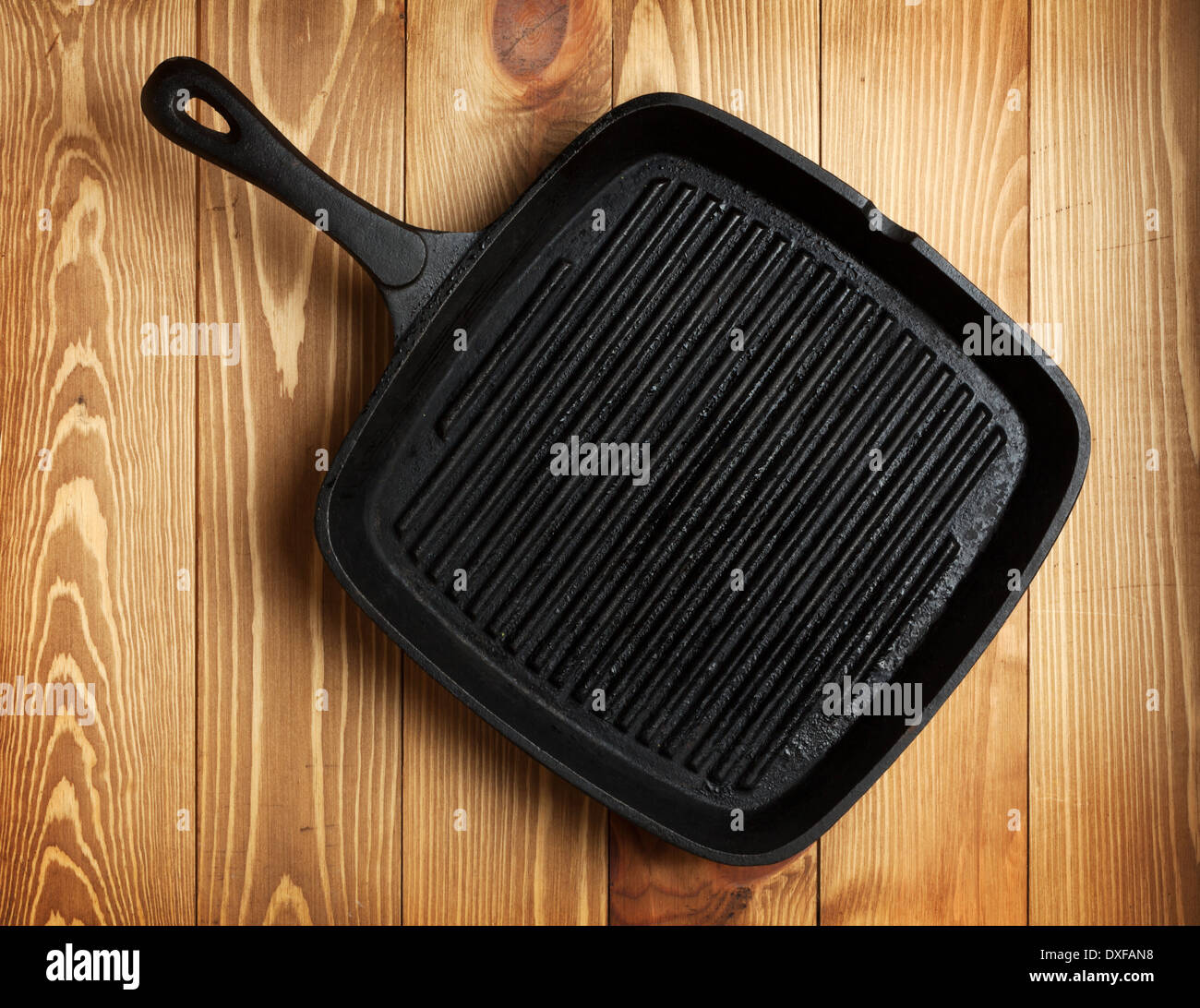 Frying pan on wooden table background. View from above Stock Photo - Alamy