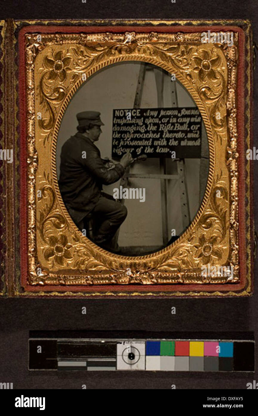 Man lettering a sign on an easel Man lettering a sign on an easel Stock ...