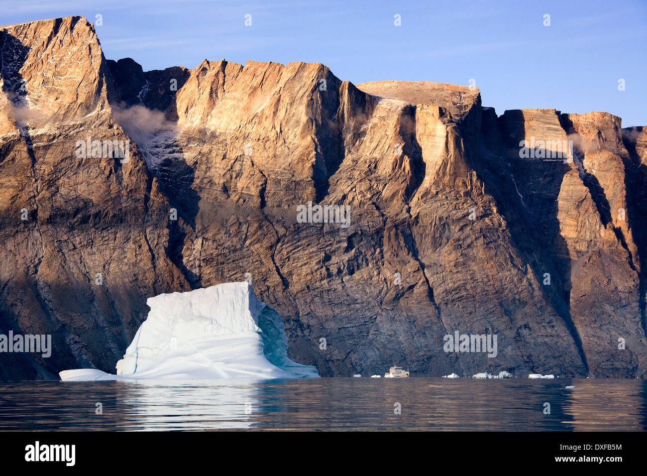 A Russian icebreaker near a large iceberg in Franz Joseph Fjord in ...