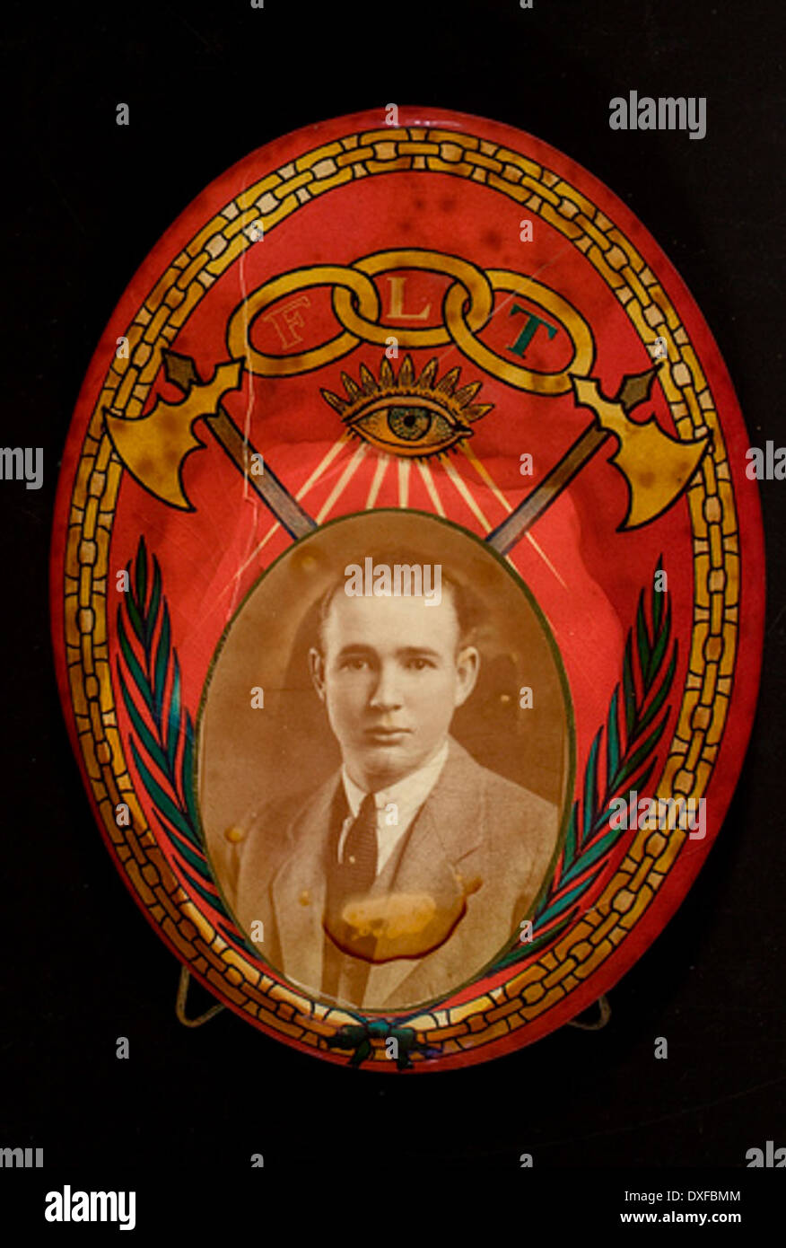 This historical image depicts a man alongside the emblem of the Order ...