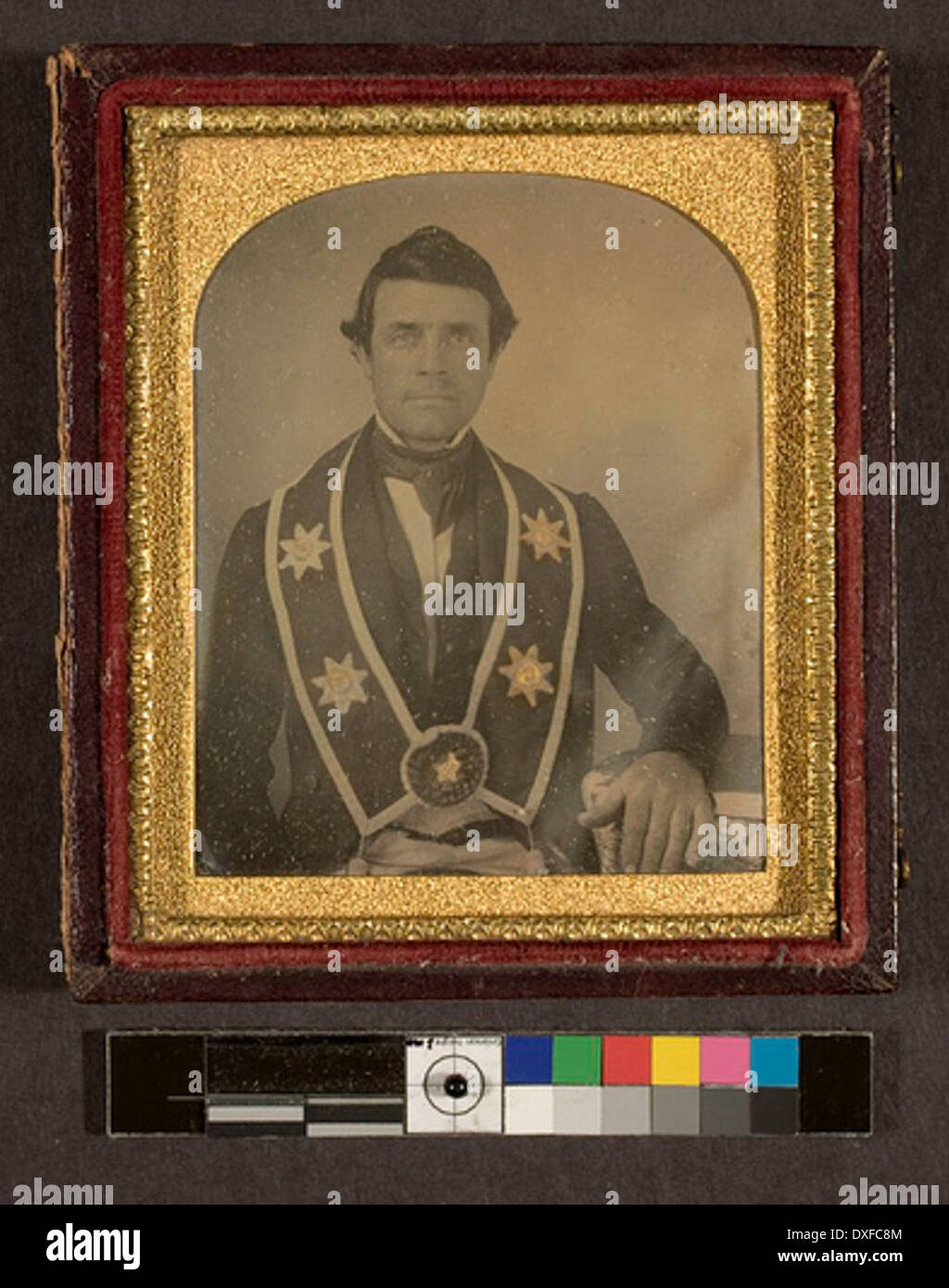 This vintage portrait depicts a man wearing the sash of a fraternal ...