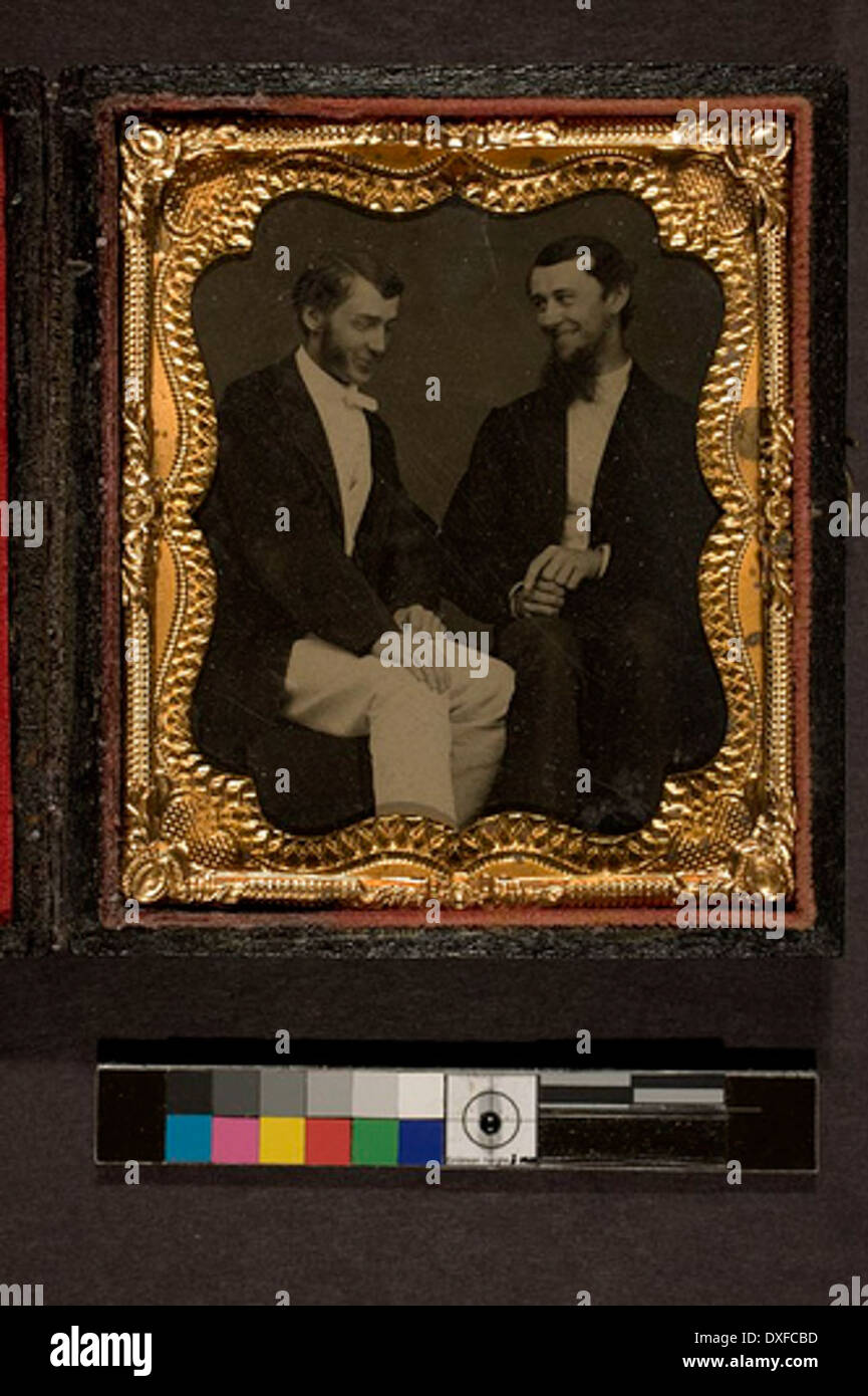 A vintage photograph depicting two men engaged in conversation. This ...