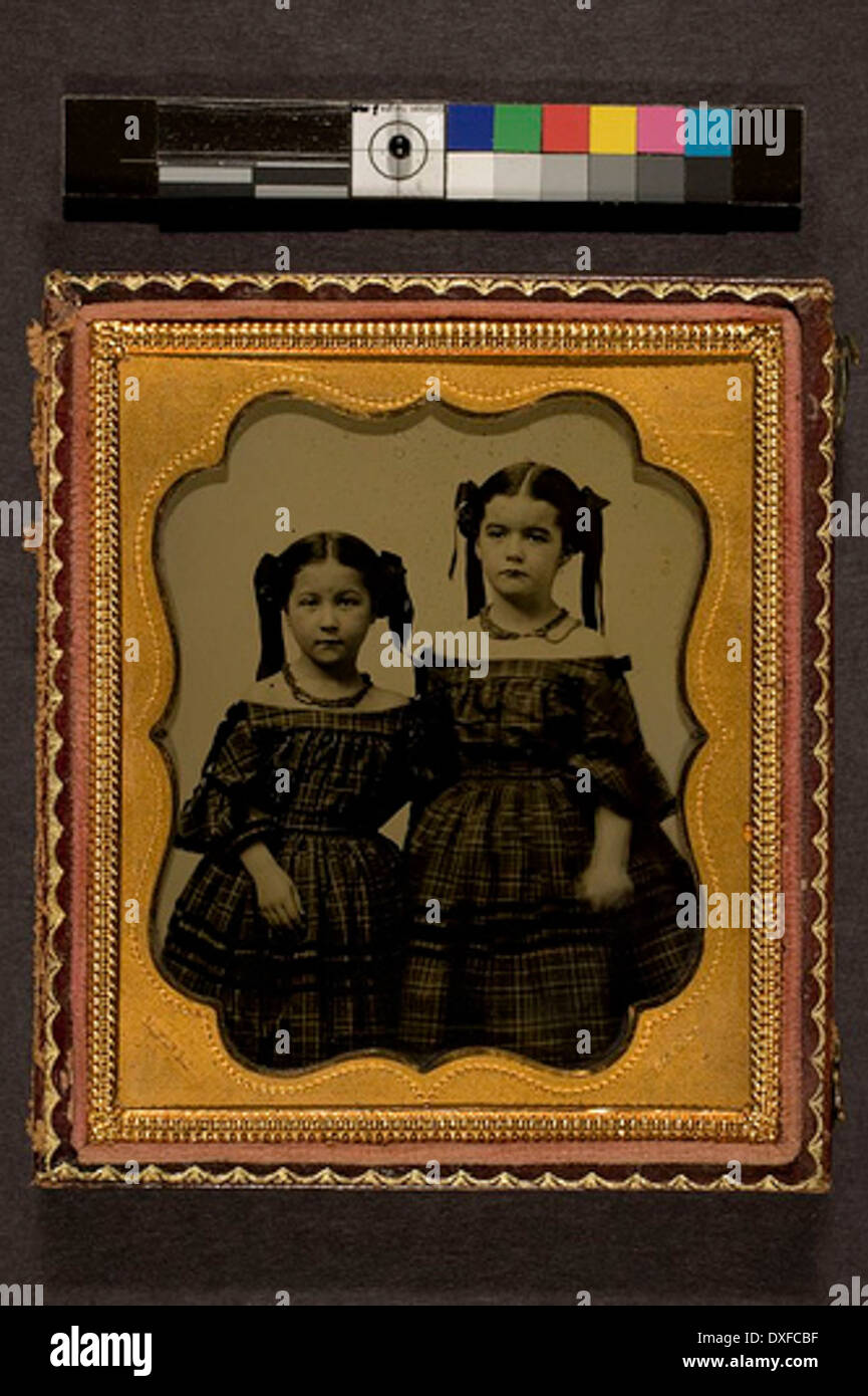 Portrait of two girls in matching dresses Portrait of two girls in ...