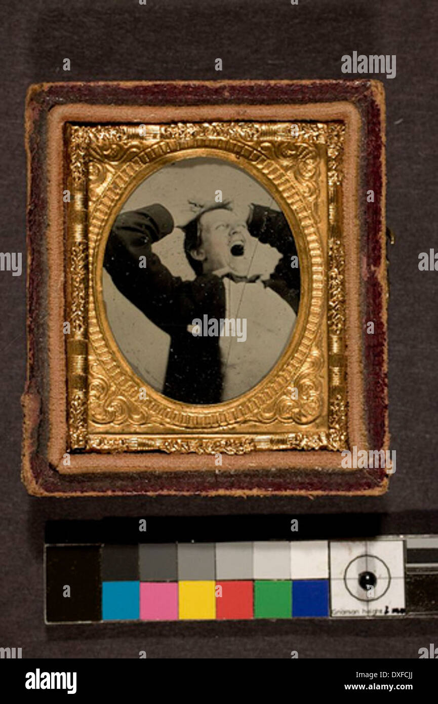 This portrait captures a young man yawning, a moment frozen in time ...