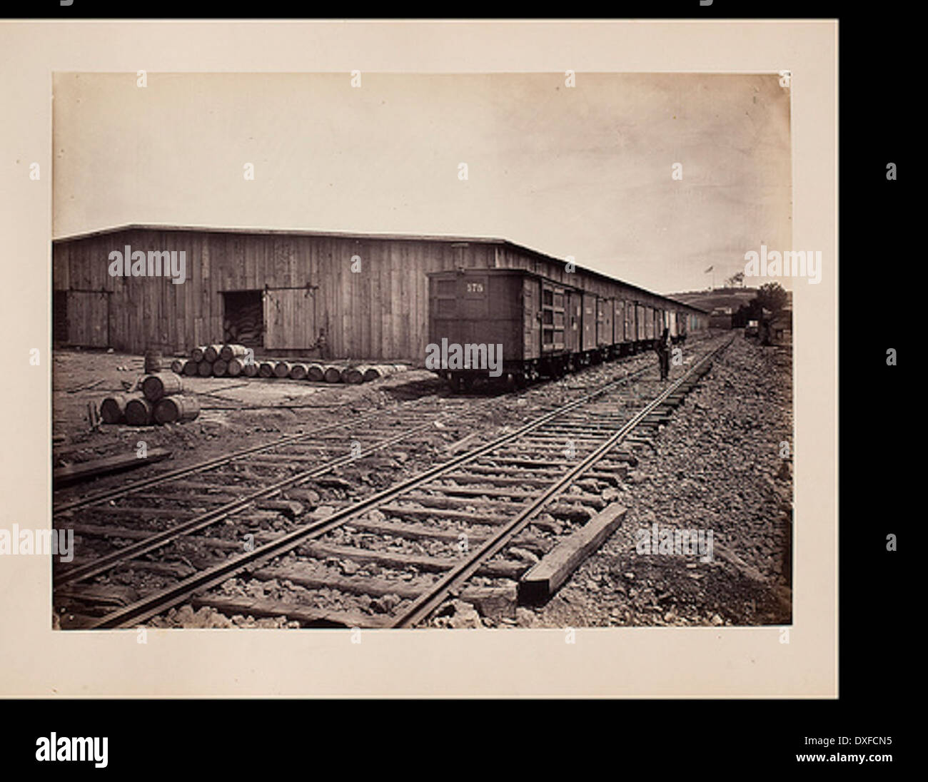 Railroad cars and warehouses in railroad yard Stock Photo - Alamy