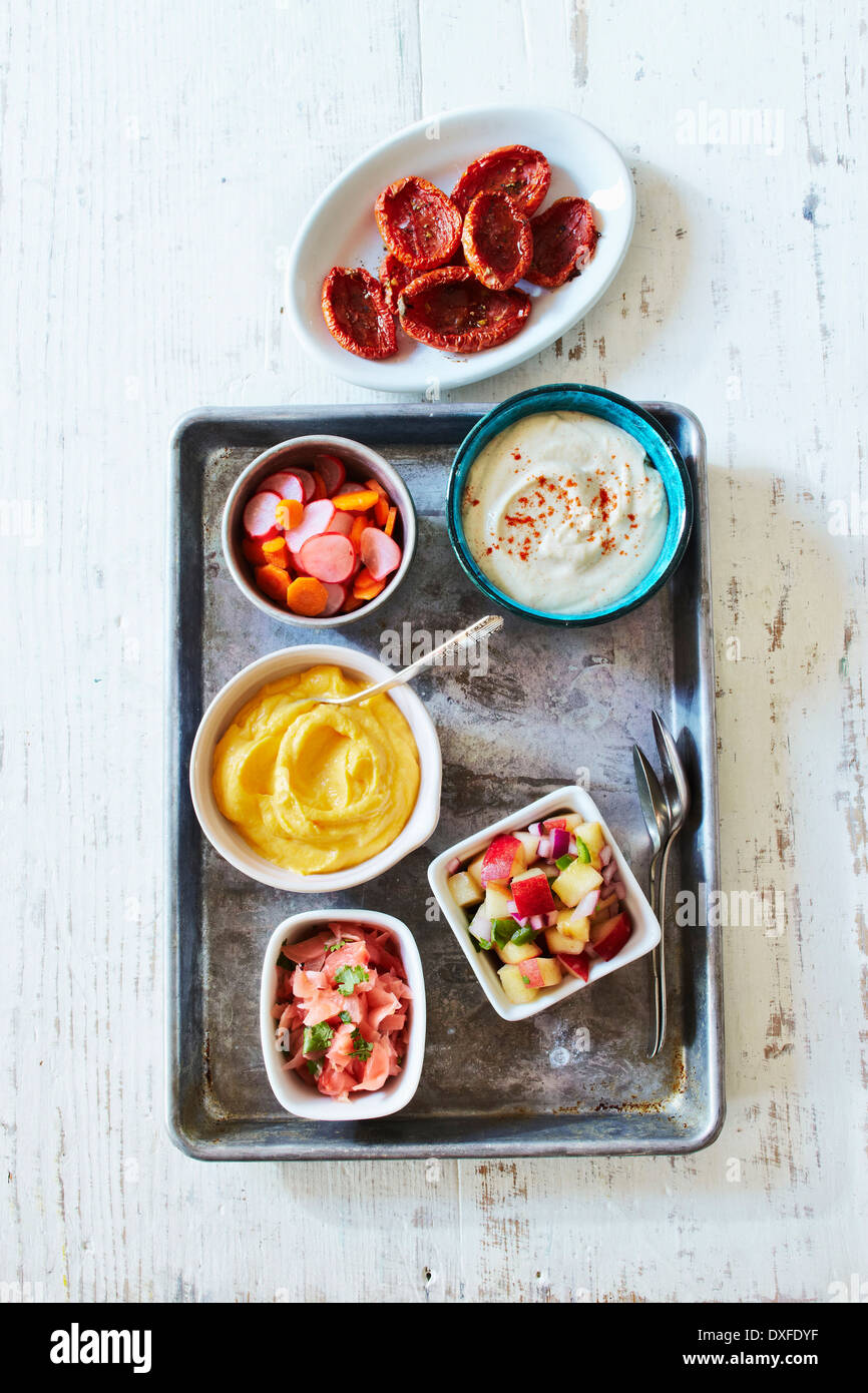 Variety of condiments in small bowls on metal tray, studio shot Stock ...