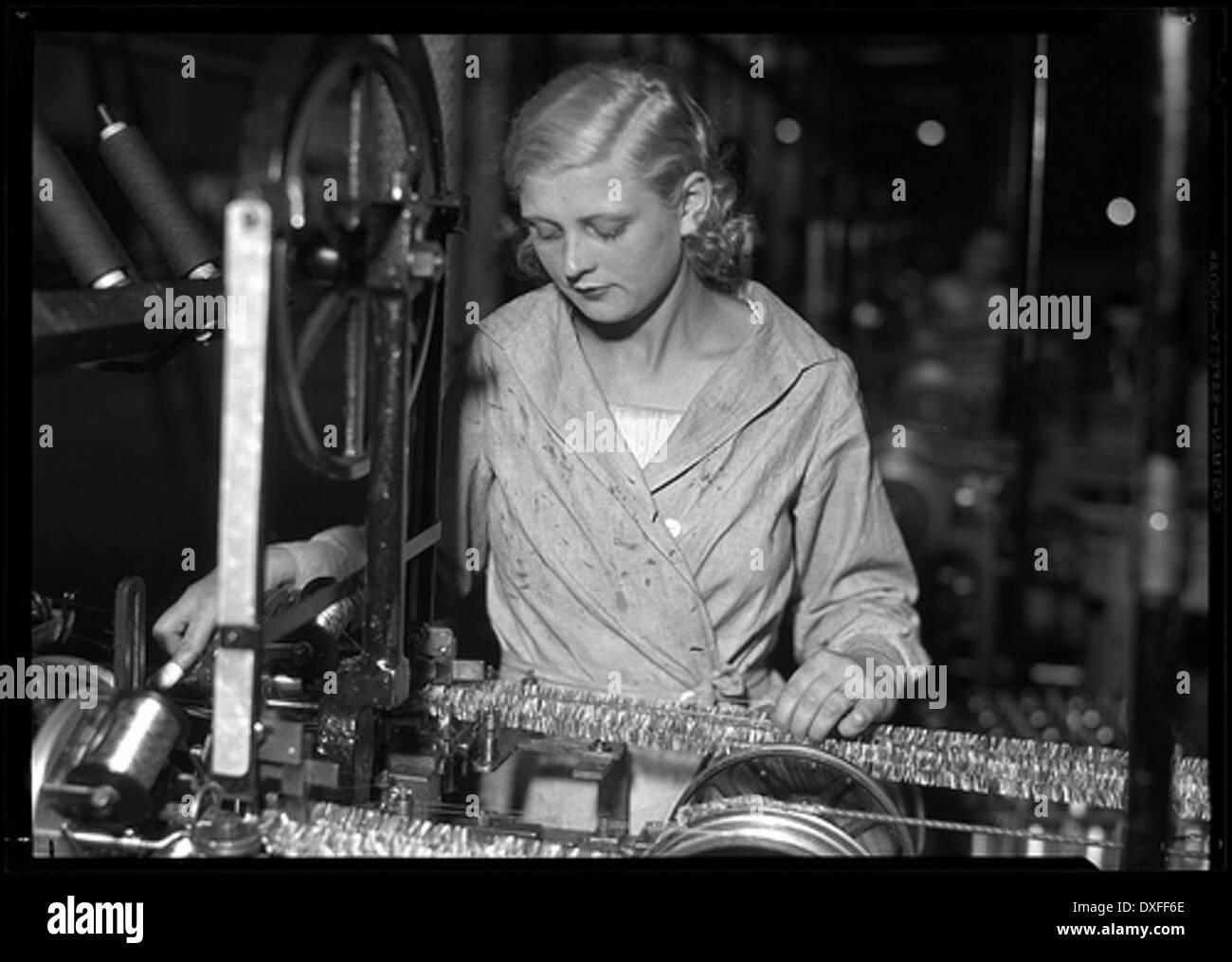 This historical image shows a woman with a machine, potentially related ...
