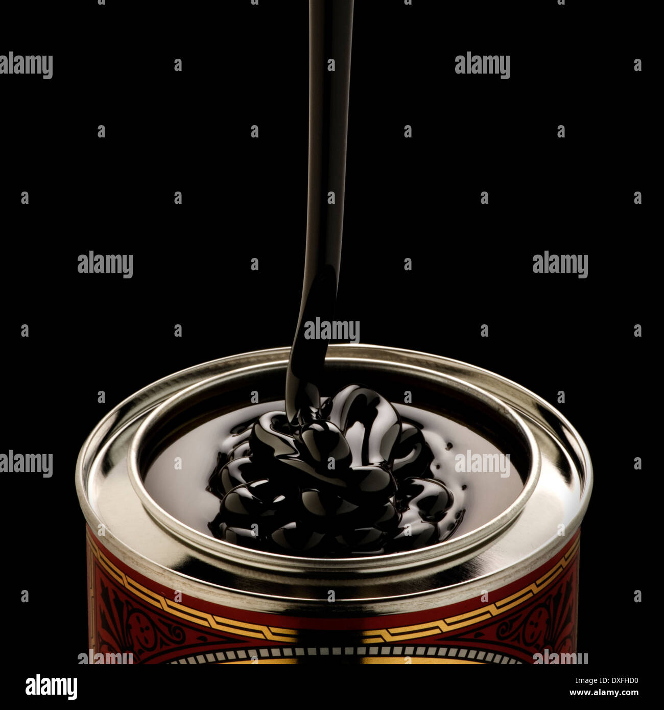 Black treacle pouring into tin Stock Photo - Alamy