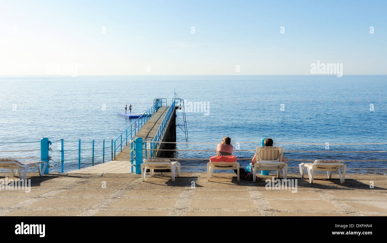 Santa Cruz Madeira Portugal. Tourist on sun beds looking out to the ...