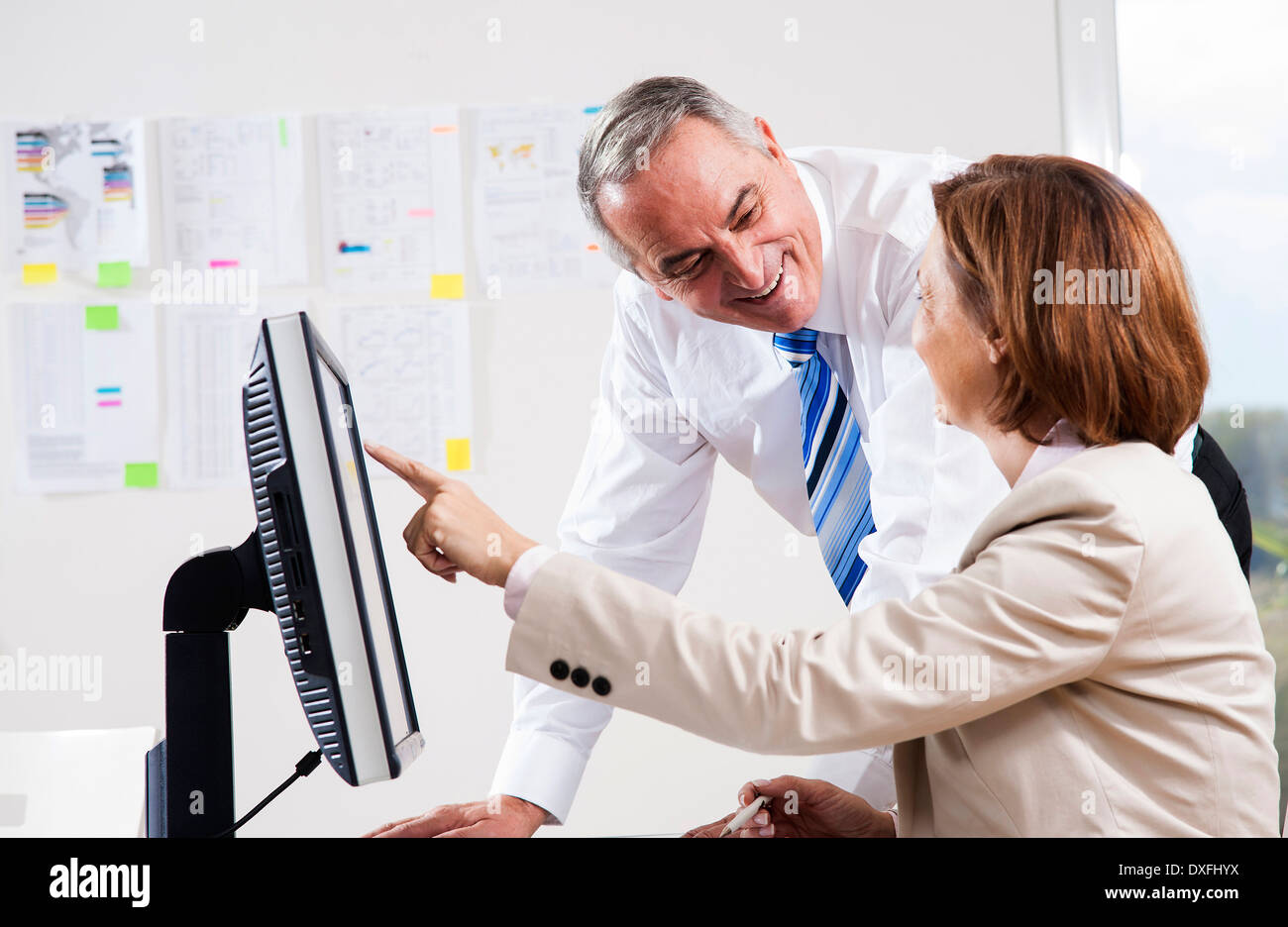 Business people pointing at monitor hi-res stock photography and images ...