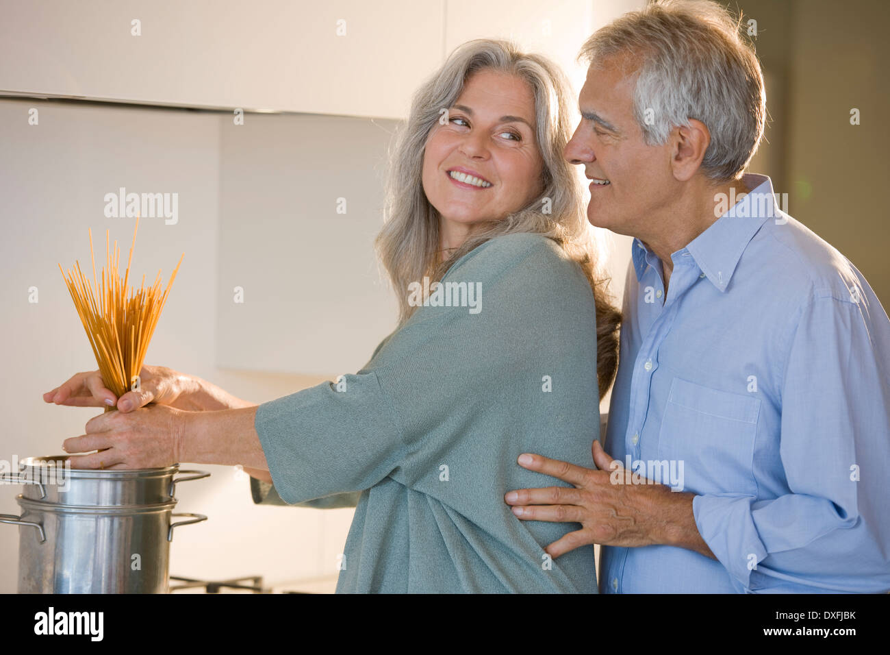Mature couple cooking spaghetti Stock Photo - Alamy