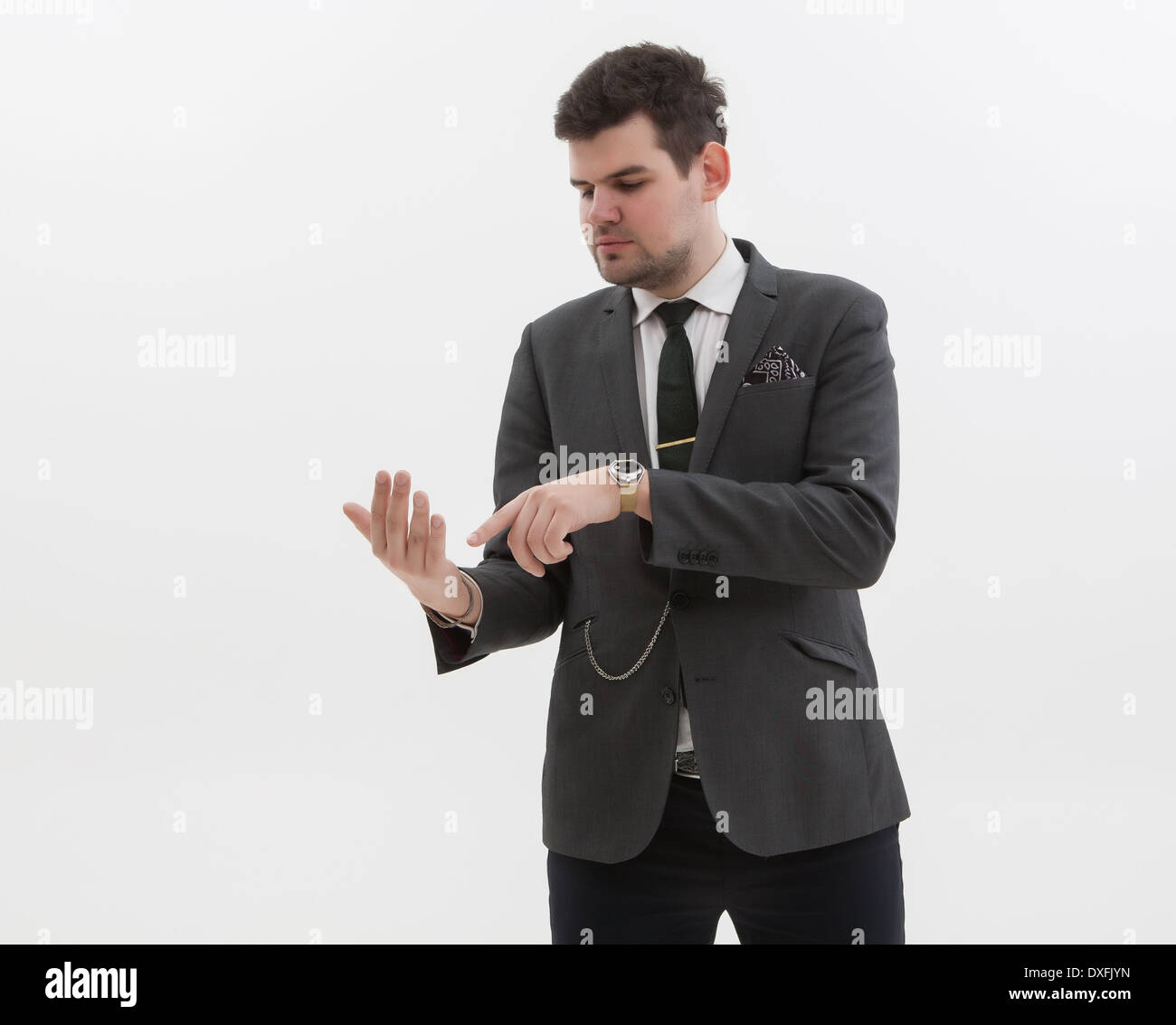 Handsome man makes a gesture with his hand. Beautiful gray suit ...