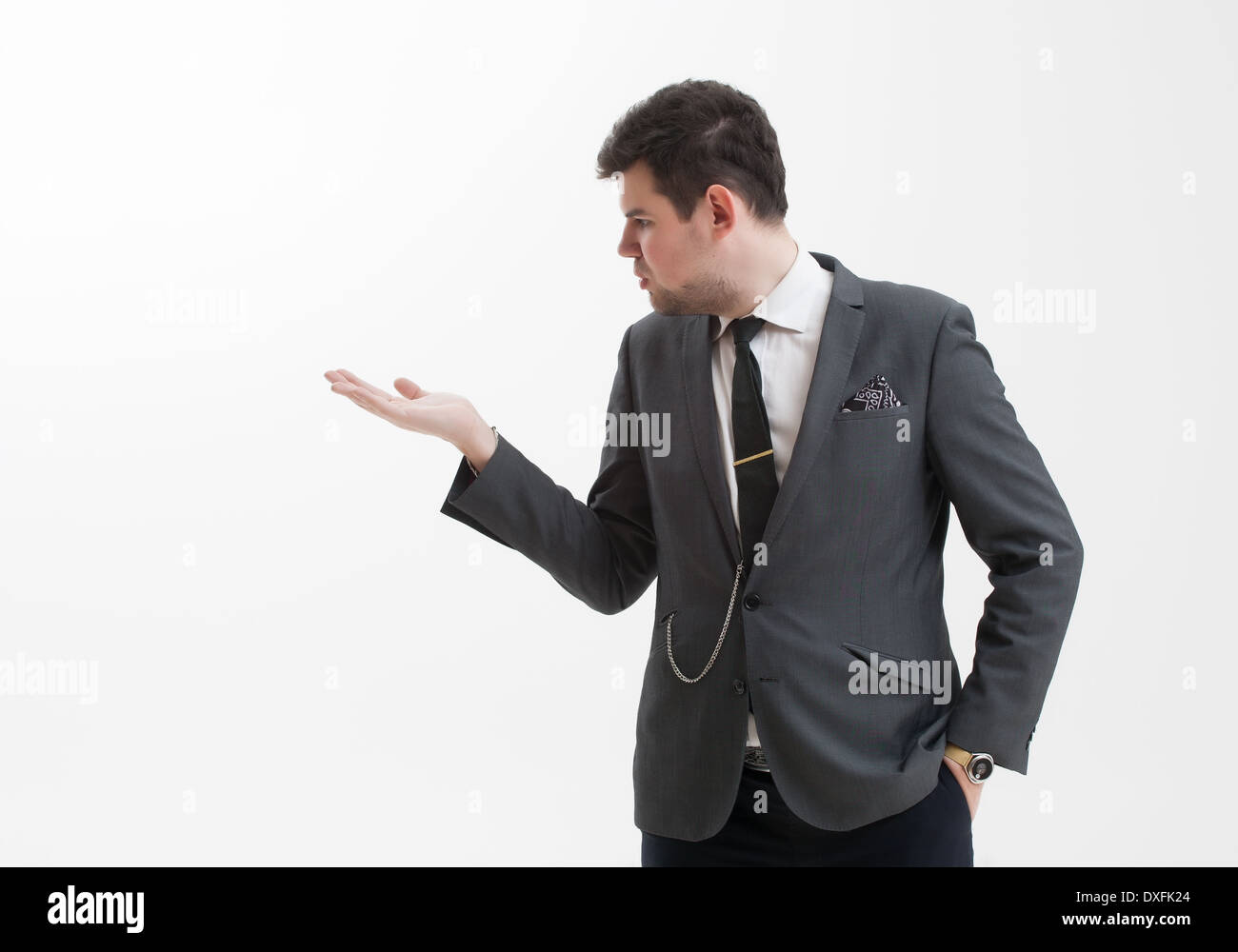 Handsome man makes a gesture with his hand. Beautiful gray suit ...