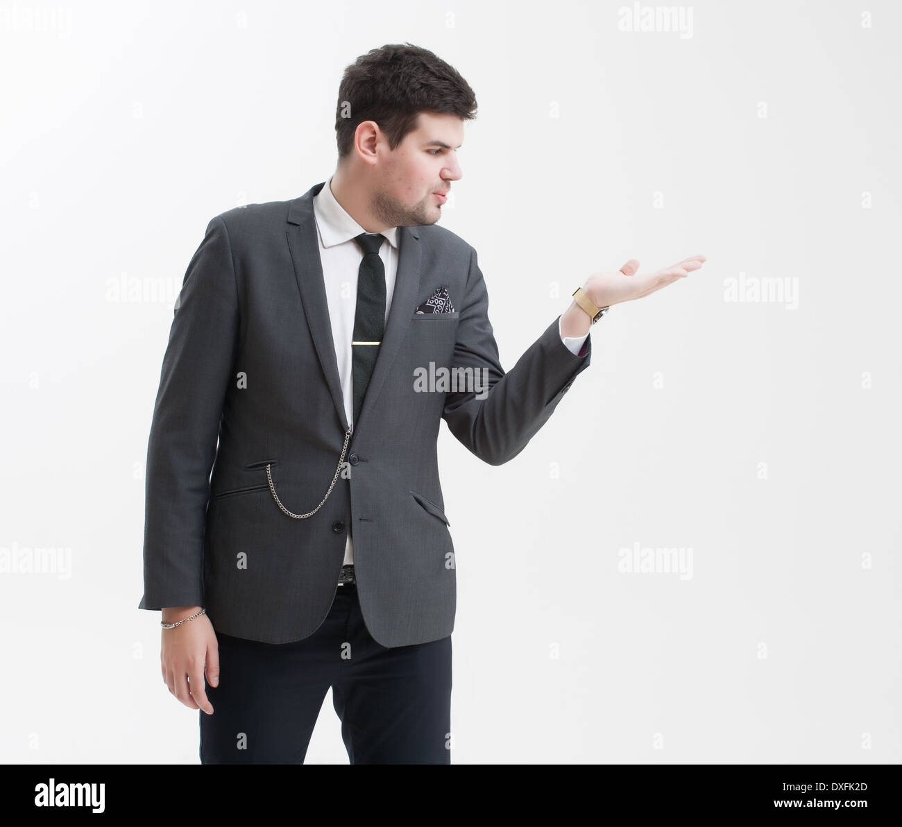 Handsome man makes a gesture with his hand. Beautiful gray suit ...