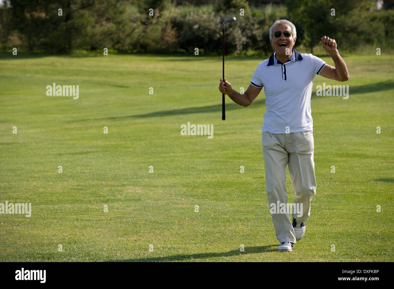 Mature man playing golf Stock Photo - Alamy