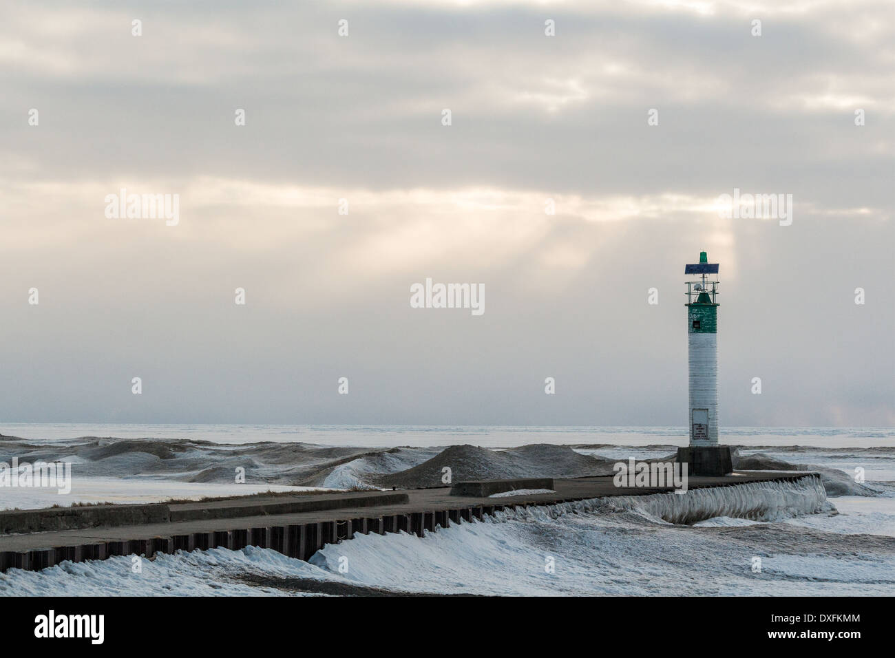 Grand Bend, Ontario. Lighthouse at the end of the pier as the sunsets ...