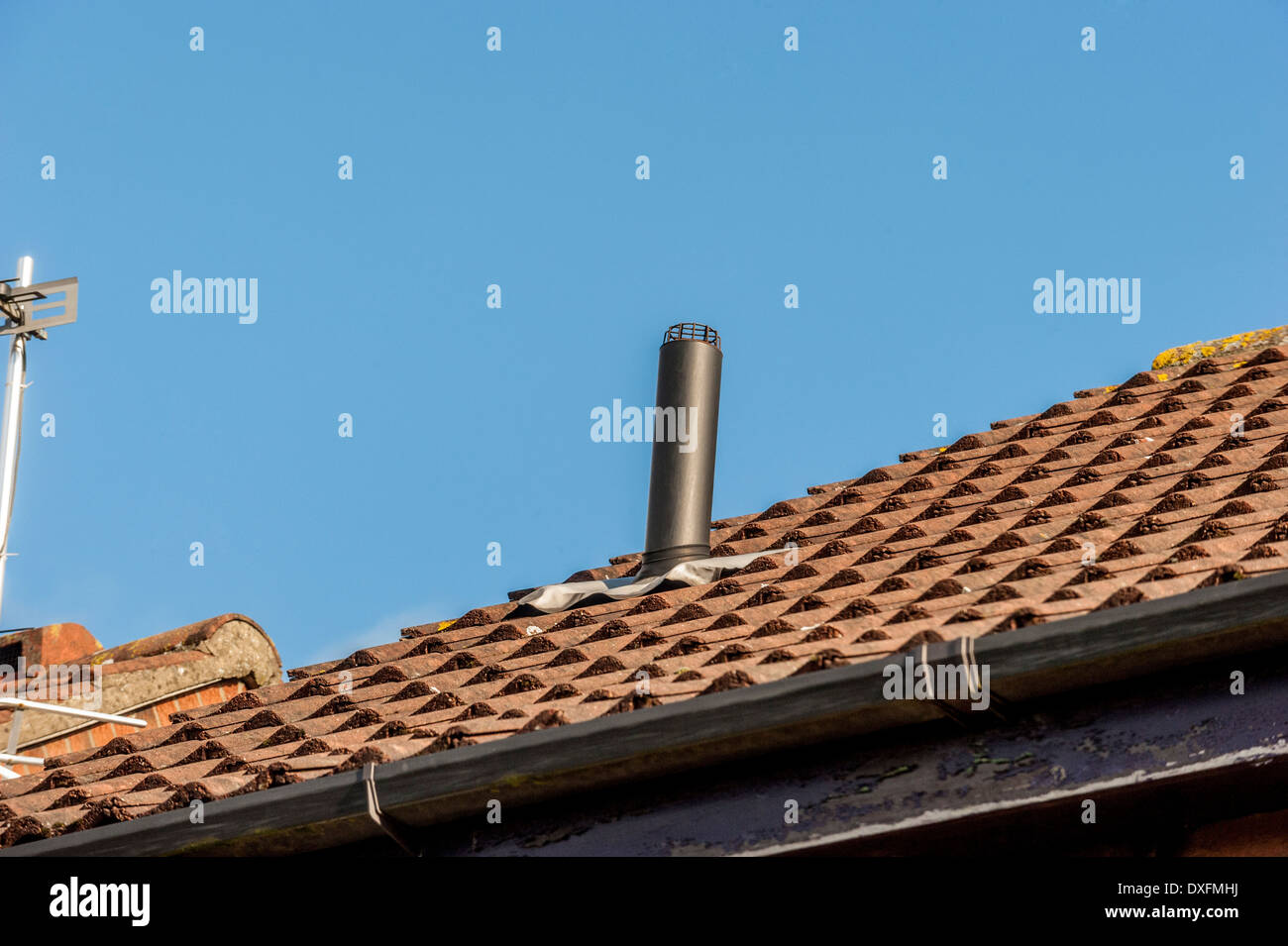 Standard domestic tiled roof on house with stench pipe Stock Photo - Alamy