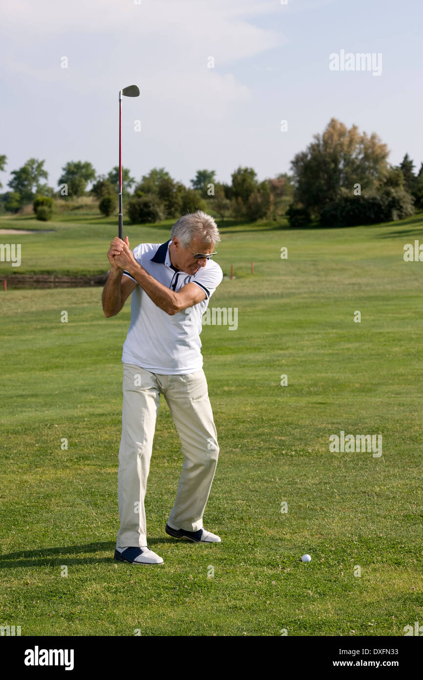 Mature man playing golf Stock Photo - Alamy