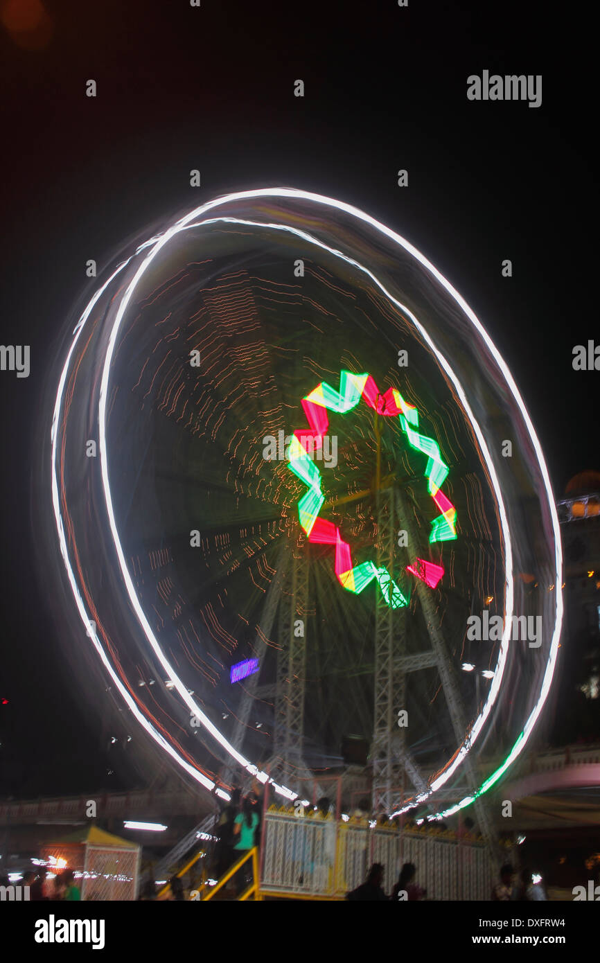 Neon sign, Ferris wheel at night, India Stock Photo - Alamy
