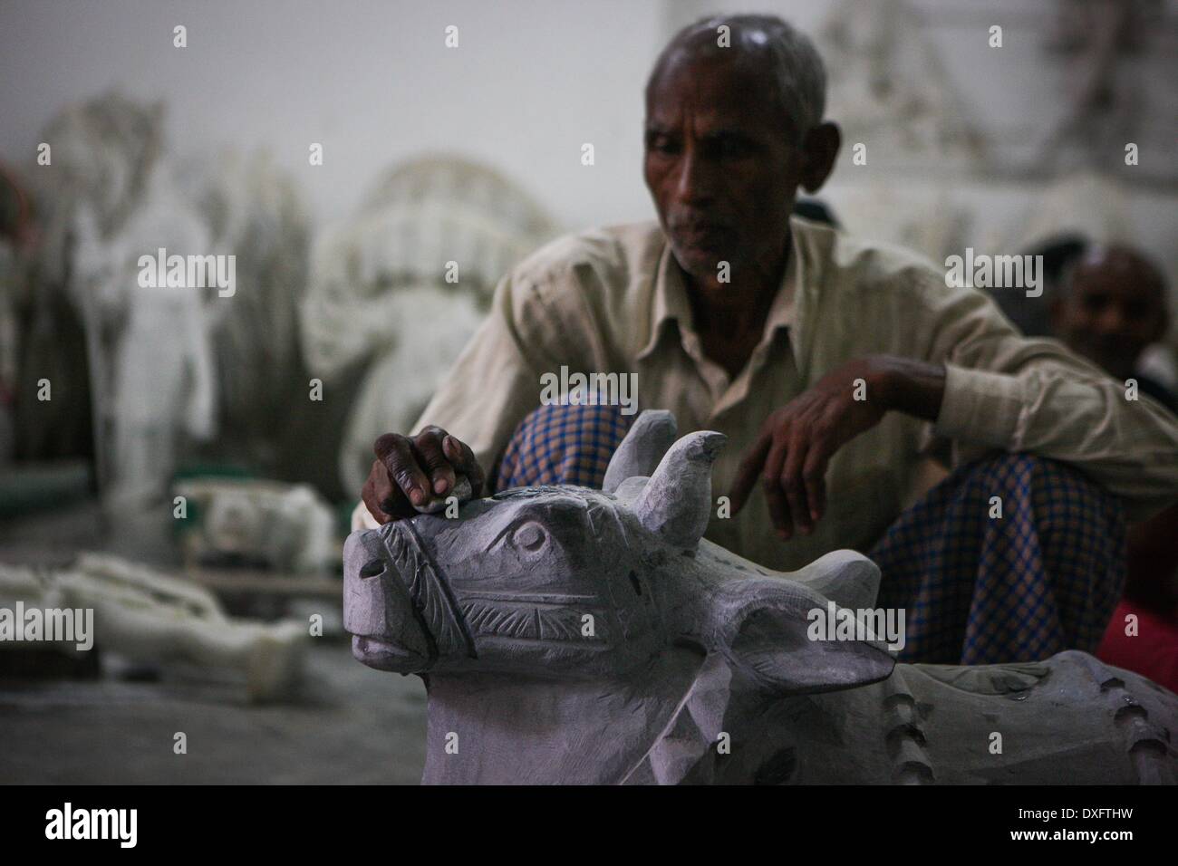 Varanasi, India. 25th Mar, 2014. A craftsman works on a stone sculpture ...