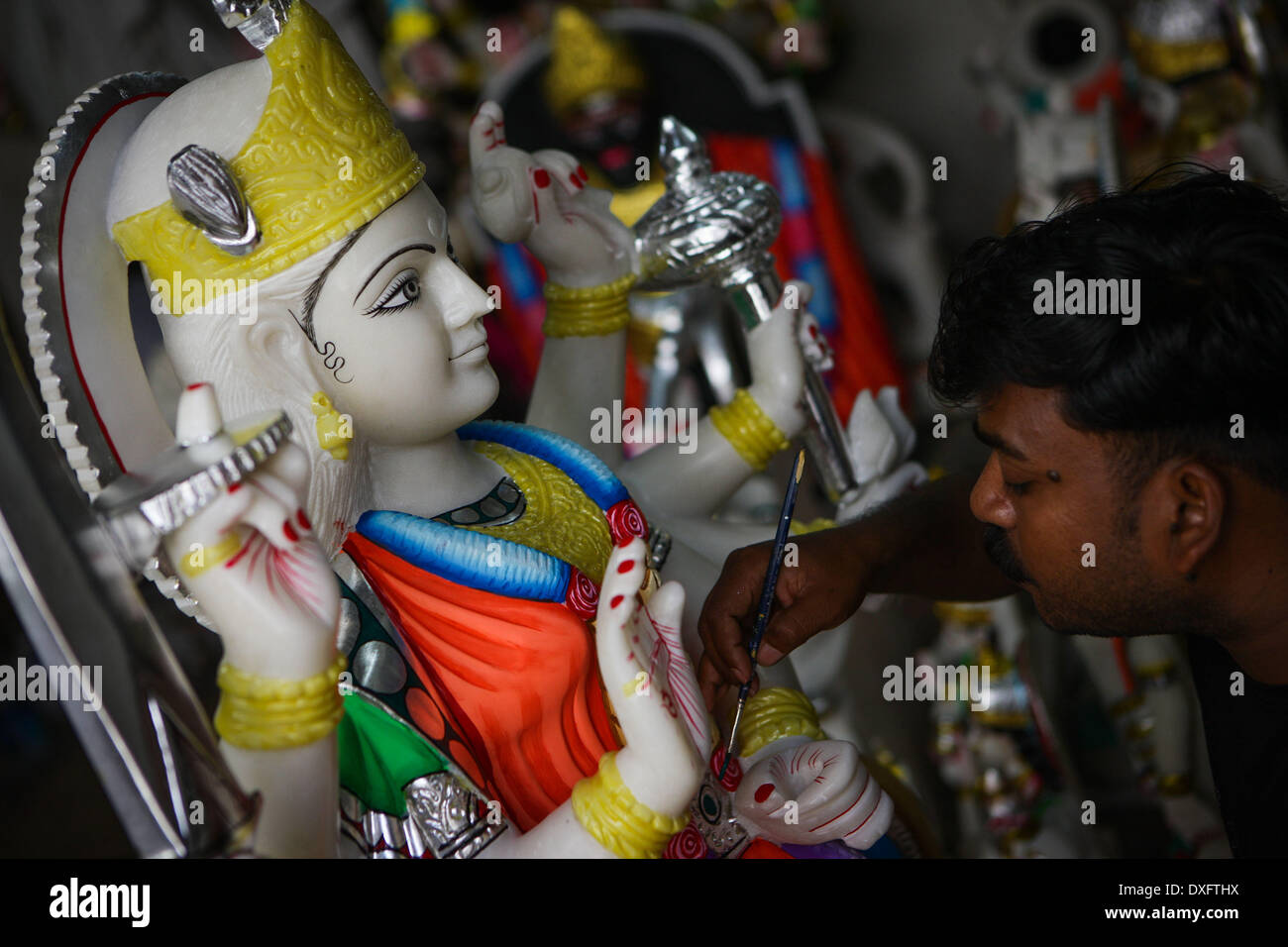 Varanasi, India. 25th Mar, 2014. A craftsman works on a stone sculpture ...