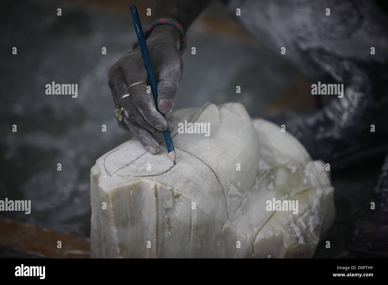 Varanasi, India. 25th Mar, 2014. A craftsman works on a stone sculpture ...