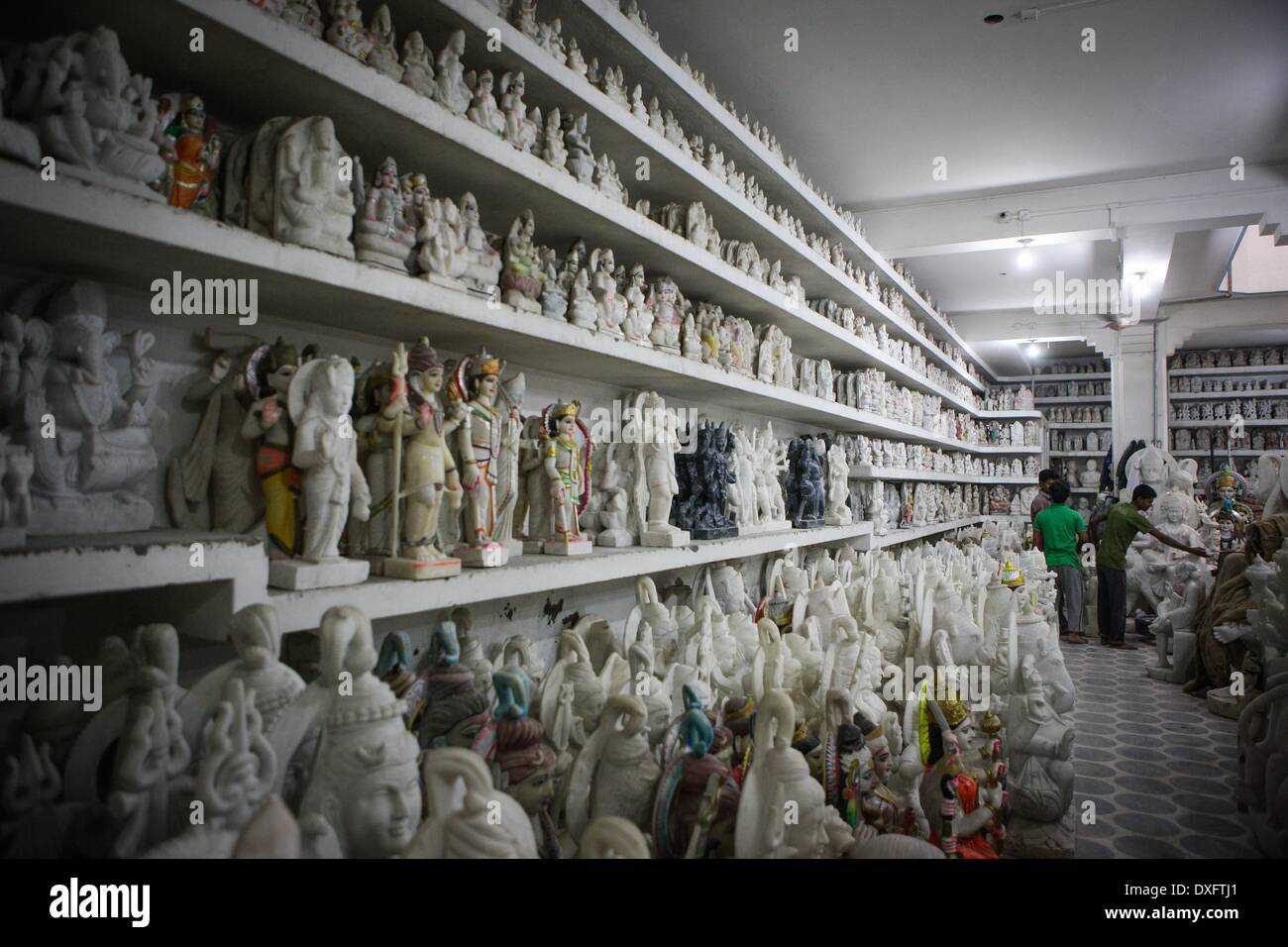 Varanasi, India. 25th Mar, 2014. Craftsmen work at a stone carving ...