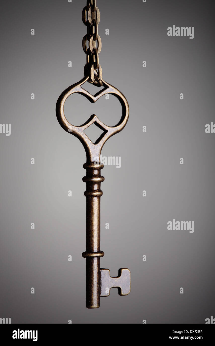 old key and chain on a grey background Stock Photo - Alamy