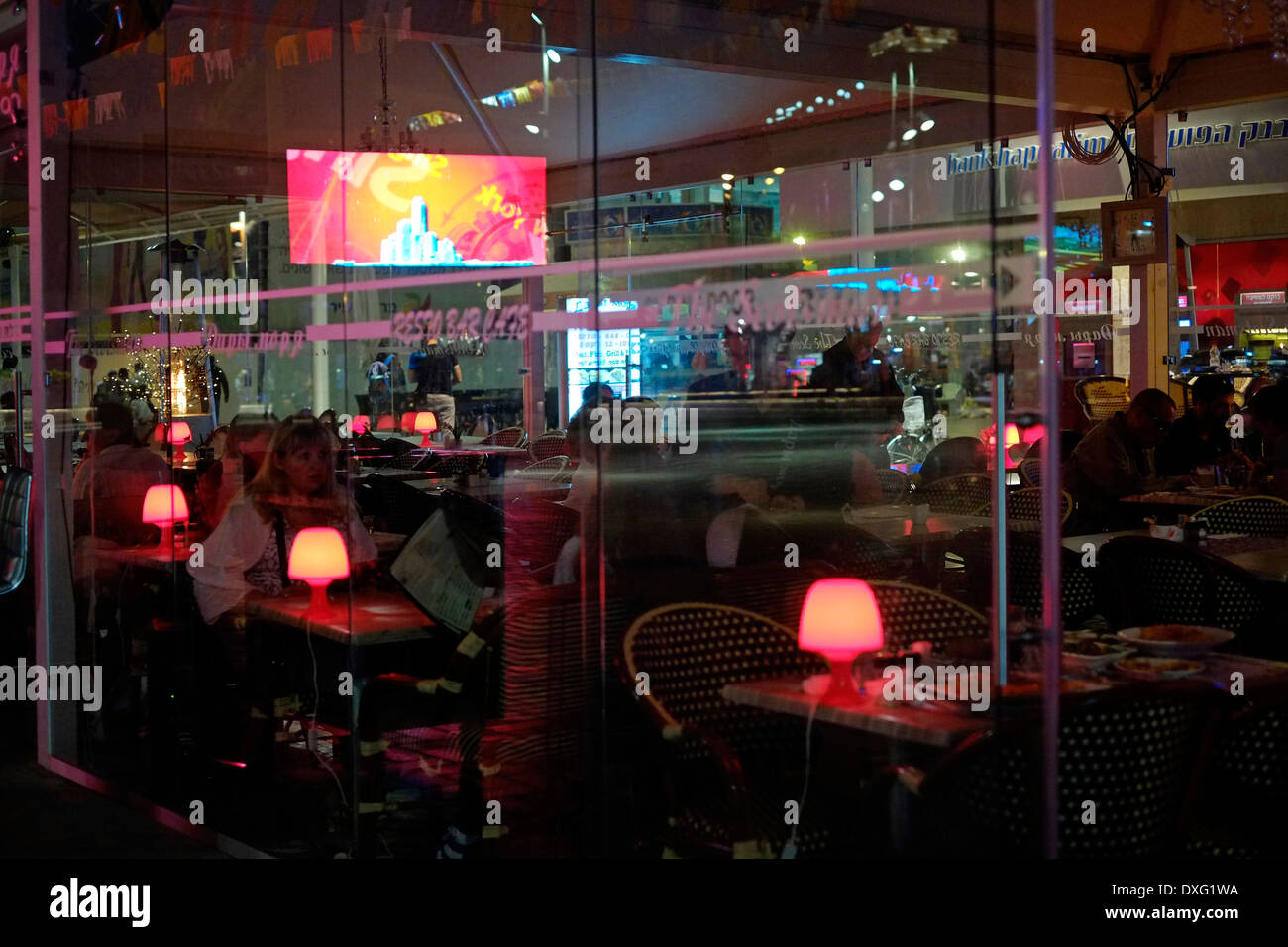 People siting in a restaurant at night in the city of Netanya Israel ...