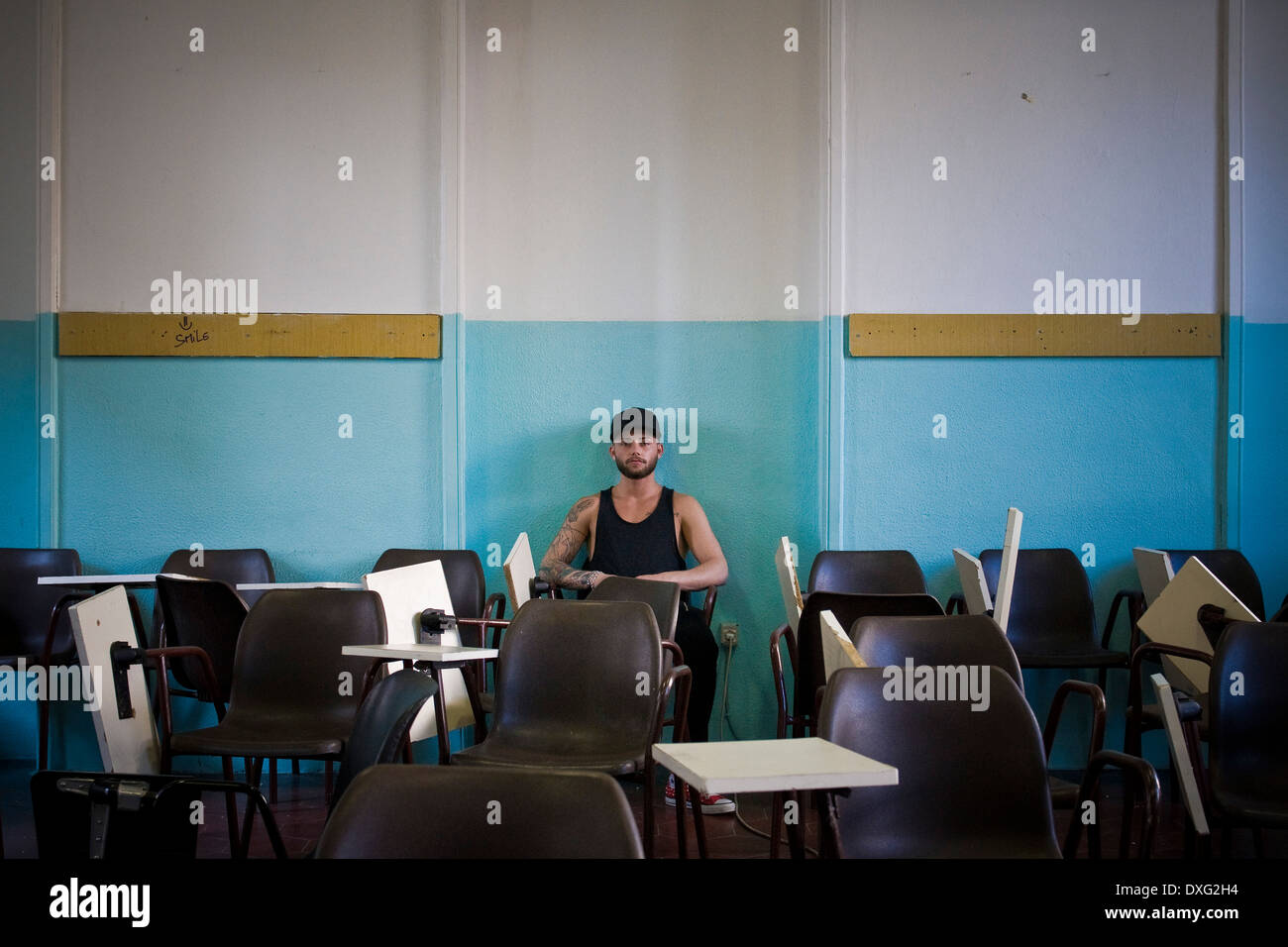 Young man sitting in the classroom Stock Photo - Alamy