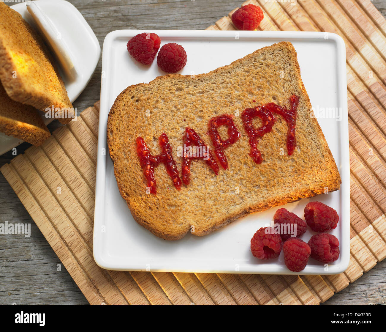 Slice Of Toast With Word Happy Written In Jam Stock Photo - Alamy