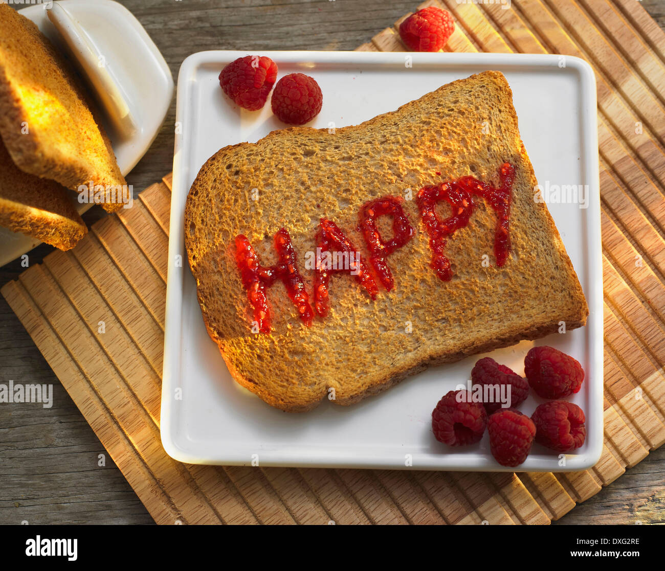 Slice Of Toast With Word Happy Written In Jam Stock Photo - Alamy