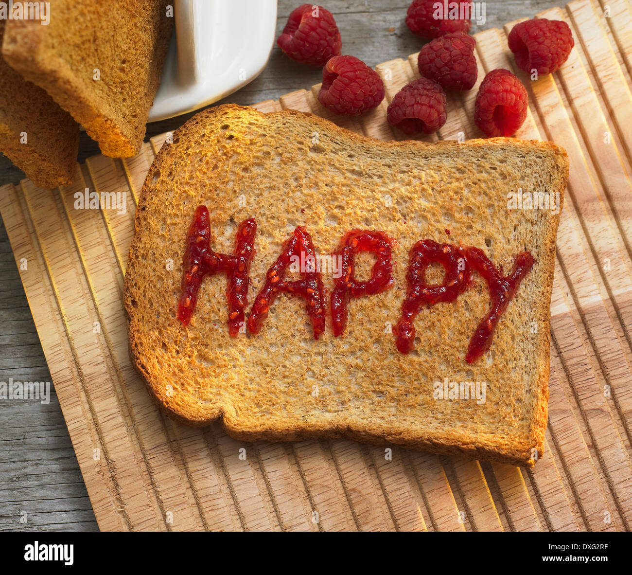 Slice Of Toast With Word Happy Written In Jam Stock Photo - Alamy