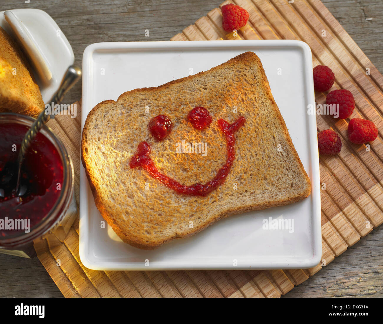 Slice Of Toast With Happy Face In Jam Stock Photo - Alamy