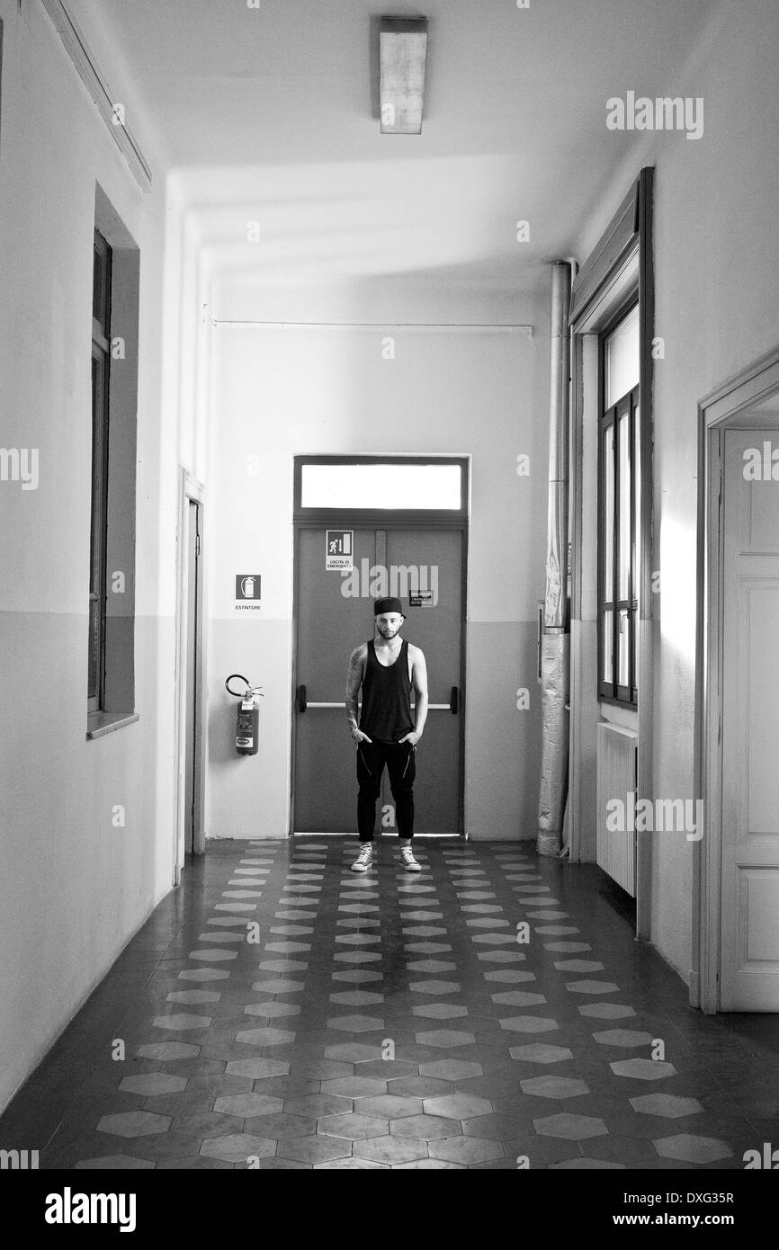 Young man standing in the hallway Stock Photo - Alamy